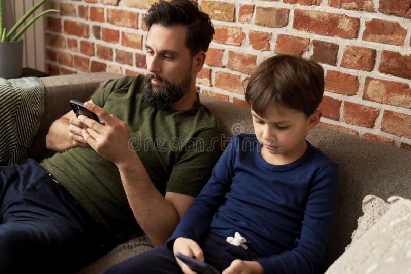 Dad and Son Using Technology at Home Stock Image - Image of father ...