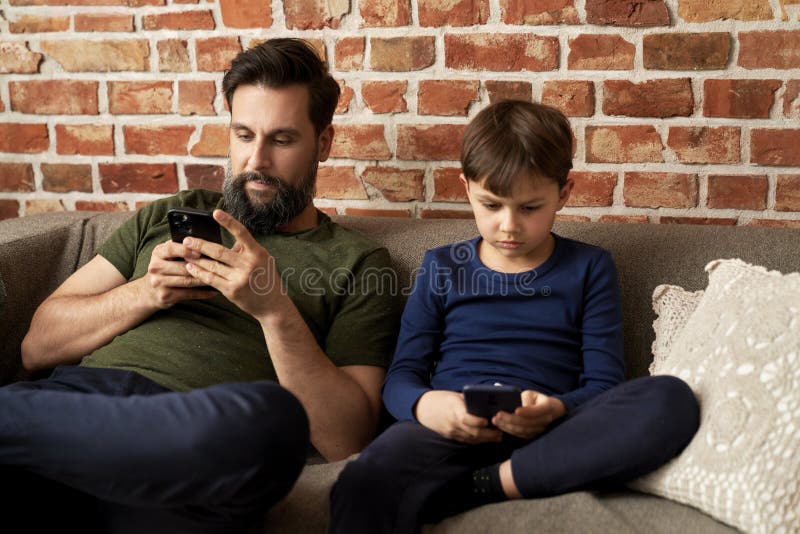 Dad and Son Using Technology at Home Stock Image - Image of boys ...