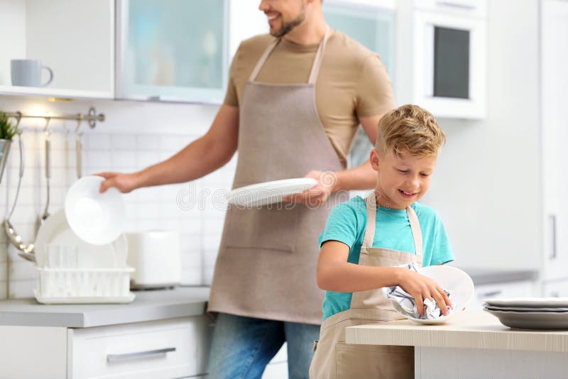 Dad and son wiping dishes stock photo. Image of clean - 158289138