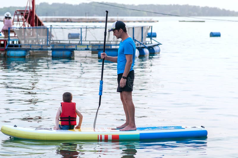 Dad and Stand-up Paddle Board Together. Stock Photo - Image of daddy ...