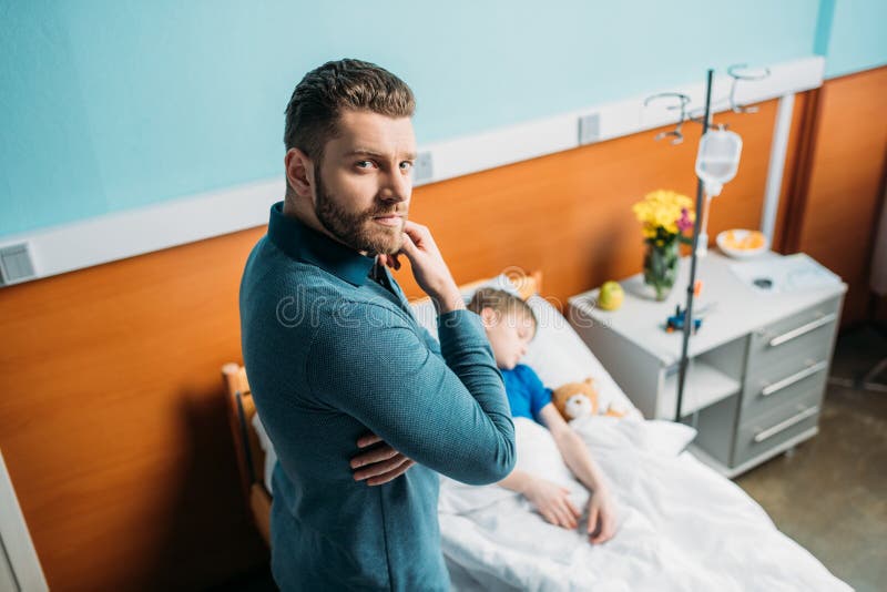 Dad Standing Near Sick Son in Hospital Bed Stock Image - Image of ...