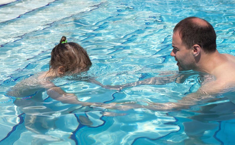 Dad Teaches His Daughter To Swim Stock Image - Image of diving, person ...