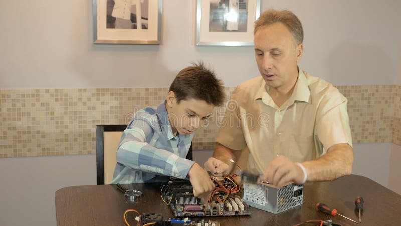 Dad Teaches His Son a Teenager, What`s Inside the Computer. the ...