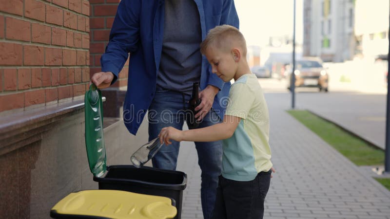 Dad Teaches His Son To Properly Sort Glass Garbage. Father and Son ...