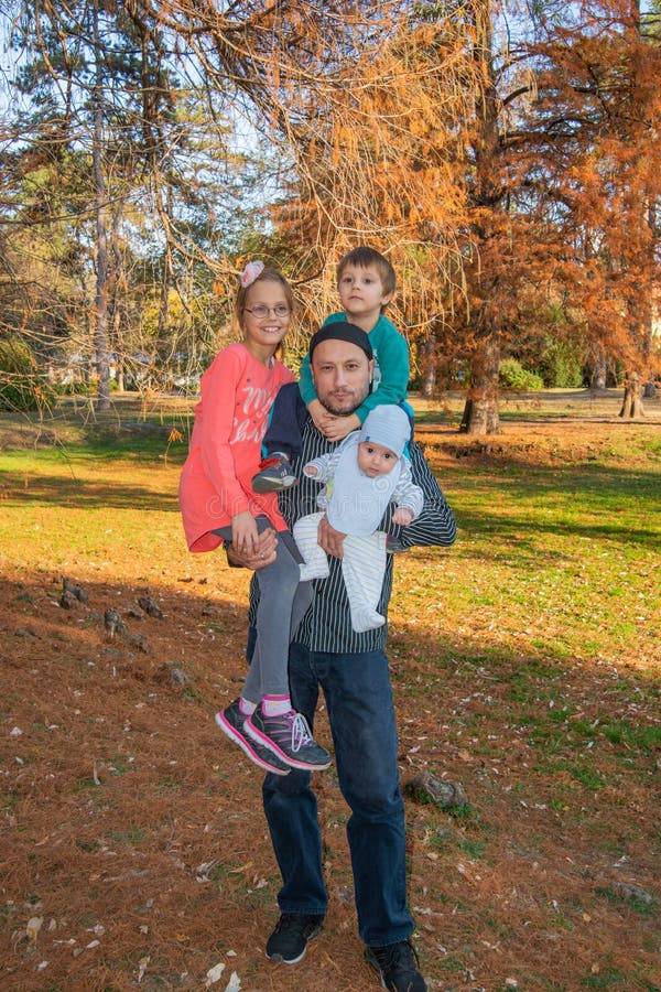 Dad with Three Children in the Arms in the Park Stock Image - Image of ...