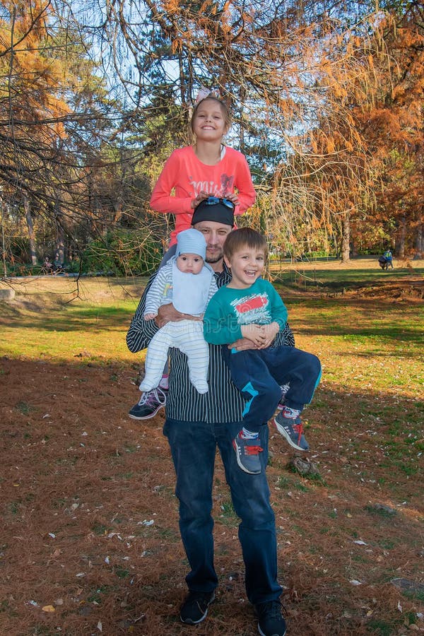 Dad with Three Children in the Arms in the Park Stock Image - Image of ...