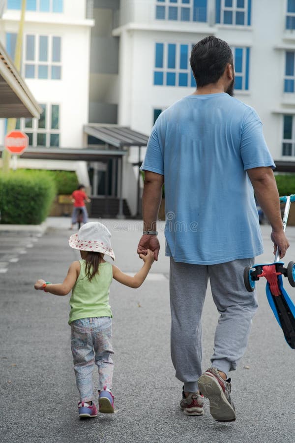 Dad Walks with Her Daughter in the Neighbourhood Stock Photo - Image of ...