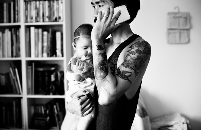 Daddy Talking Mobile Phone while Carrying His Baby Stock Photo - Image ...