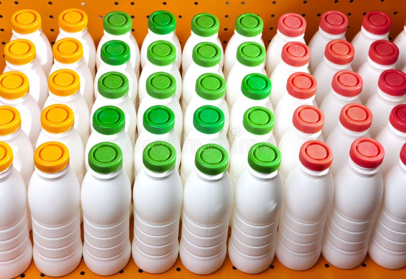 Dairy Products Bottles with Bright Covers on a Shelf in the Shop Stock ...