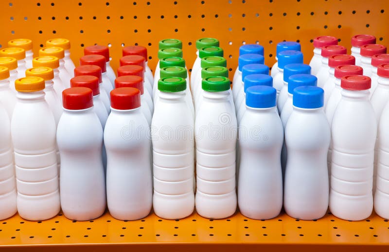 Dairy Products Bottles with Bright Covers on a Shelf in the Shop Stock ...