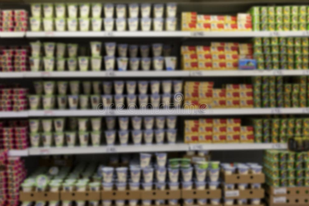 Dairy Products on the Shelves in the Store. Blurred Stock Image - Image ...