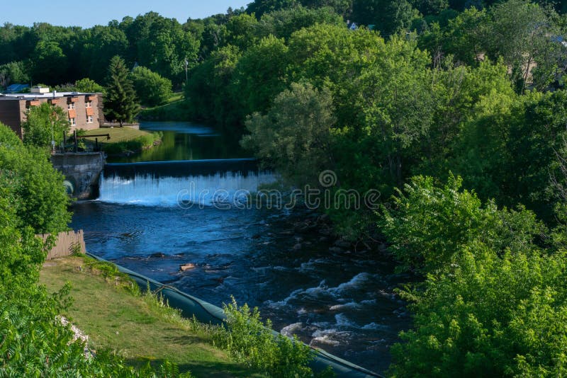 A Dam Forming a Waterfall on the River Stock Photo - Image of leaves ...