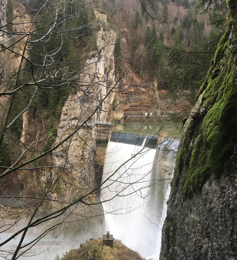 Dam with Heavy Running Water in between Cliffs and Woods Stock Photo ...