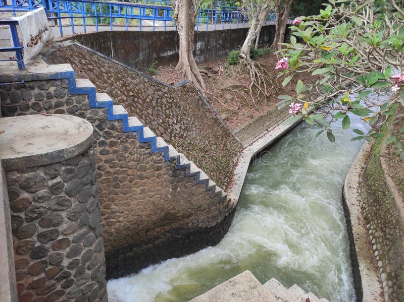 A Dam or Weir Structure with a Spillway and Steps Leading Down To the ...