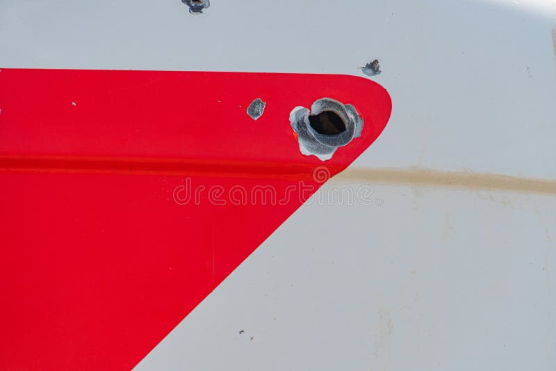 Damage after Shelling. Bullet Holes in the Red Metal. Old Rusty Surface ...