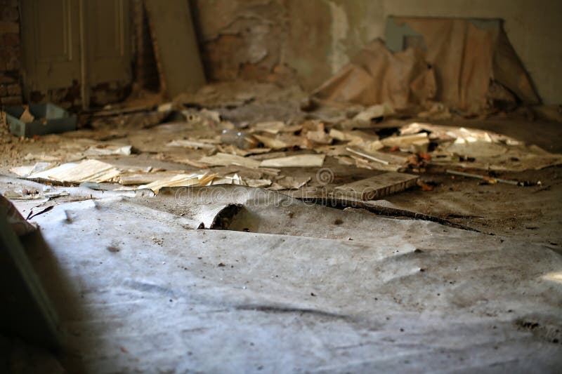 Damaged Bulging Floor Covered in Torn Paper, Dust, and Debris Inside an ...