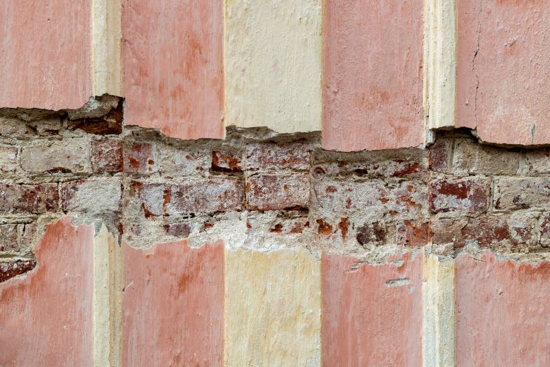 The Damaged Facade of the Building. Brickwork is Visible Under a Layer ...