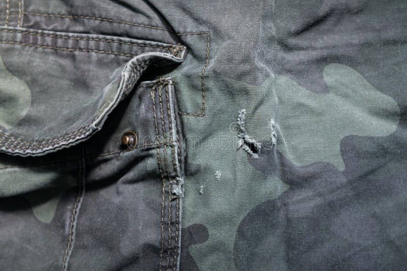 Damaged Military Uniform. Hole in Camouflage Fabric Stock Photo - Image ...