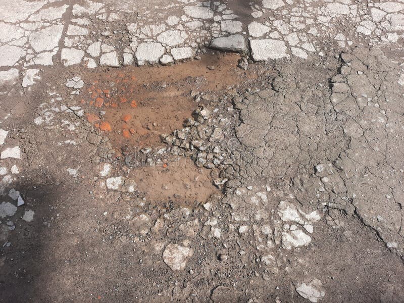 Damaged Road Surface with a Water-filled Pothole Stock Image - Image of ...