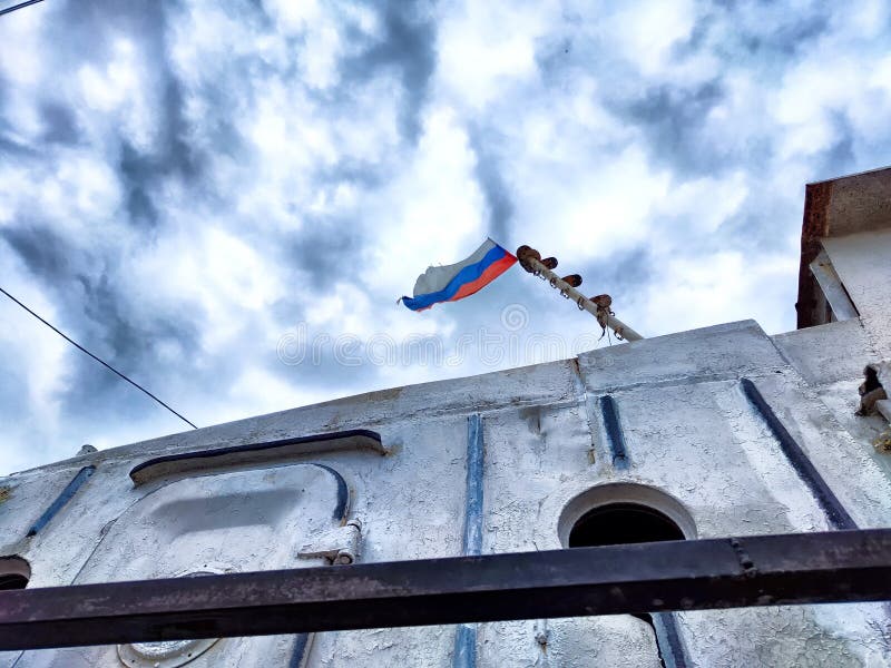 A Damaged Russian Flag Waves Atop a Ship, Highlighting Battle Scars ...