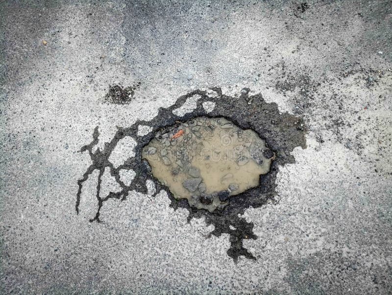 Damaged Surface of Asphalt Floor, a Big Hole on the Road with Water ...