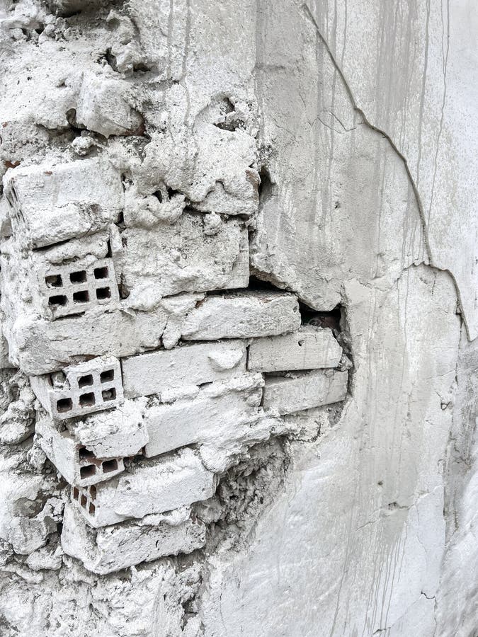 Damaged Wall of a Building with Broken Bricks Stock Photo - Image of ...