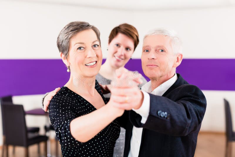 Dance Instructor with Senior Couple Stock Photo - Image of hobby ...