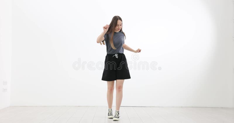 Dance Student in Minimalist Studio Demonstrating Footwork and Musical ...
