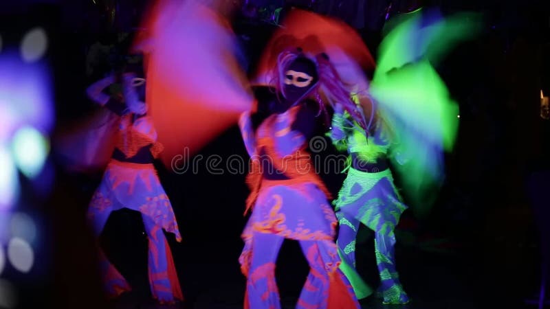 Dancers in Glowing Neon Costumes Perform in a Dark Room Stock Video ...
