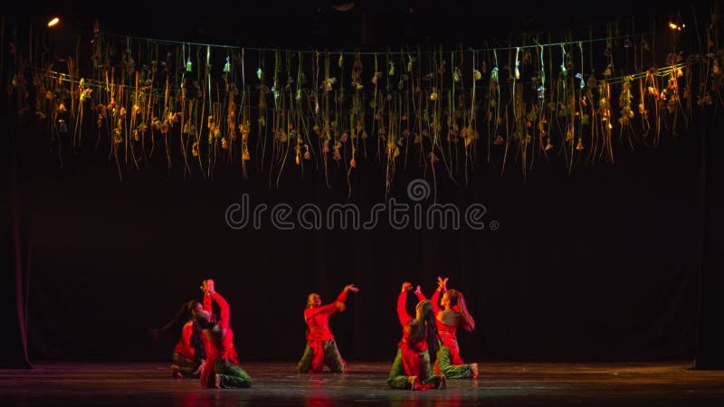 Contemporary Dance Performance with Dancers in Red Under Dramatic ...