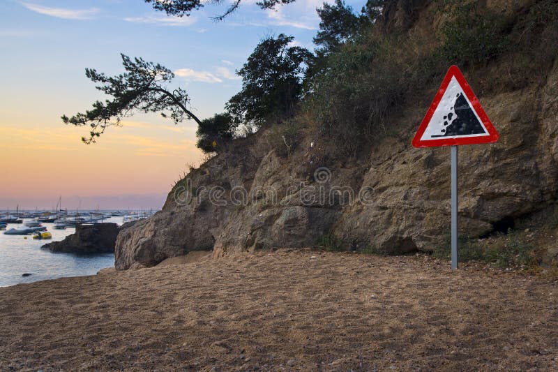 Danger Falling Rocks Sign on Mediterranean Beach Stock Photo - Image of ...