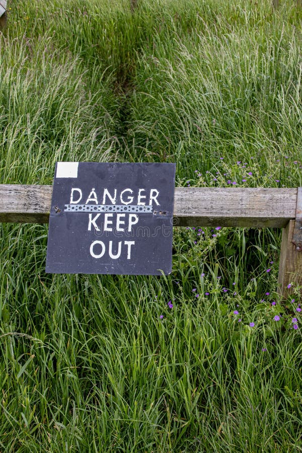 Danger Keep Out Sign Amid Grass and Flowers Stock Image - Image of ...