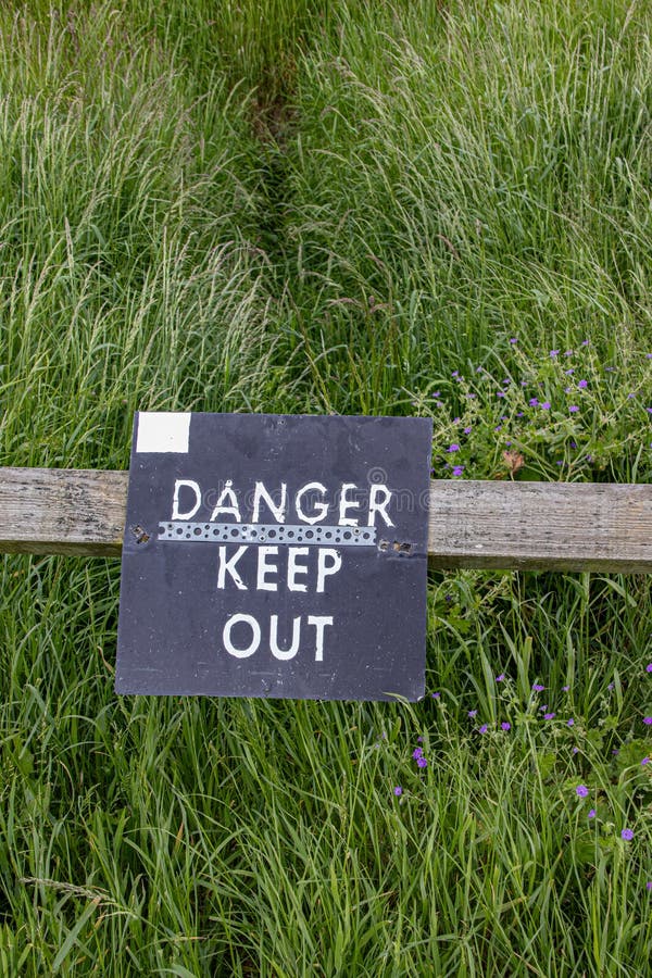Danger Keep Out Sign Amid Grass and Flowers Stock Image - Image of ...