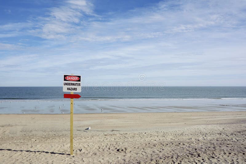 Danger Underwater Hazard Sign Posted on an Empty Ocean Beach Stock ...