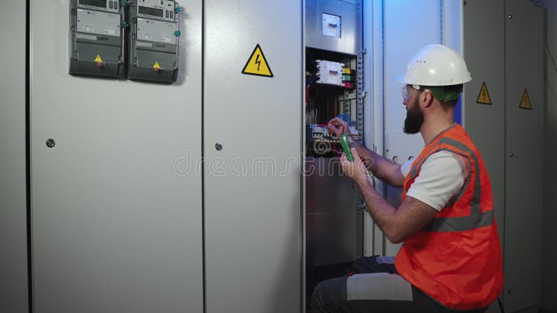 Danger Work with Electricity, Engineer is Checking Function of Circuit ...