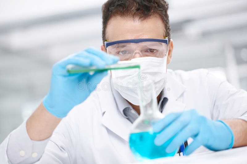 Dangerous Experiment. Closeup of a Chemist Pouring Two Chemicals ...