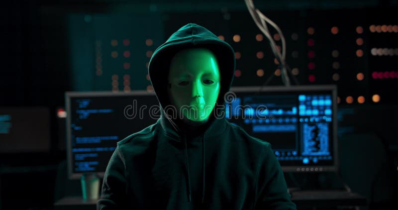 Dangerous Internationally Wanted Hacker with Masked Face Speaks into ...