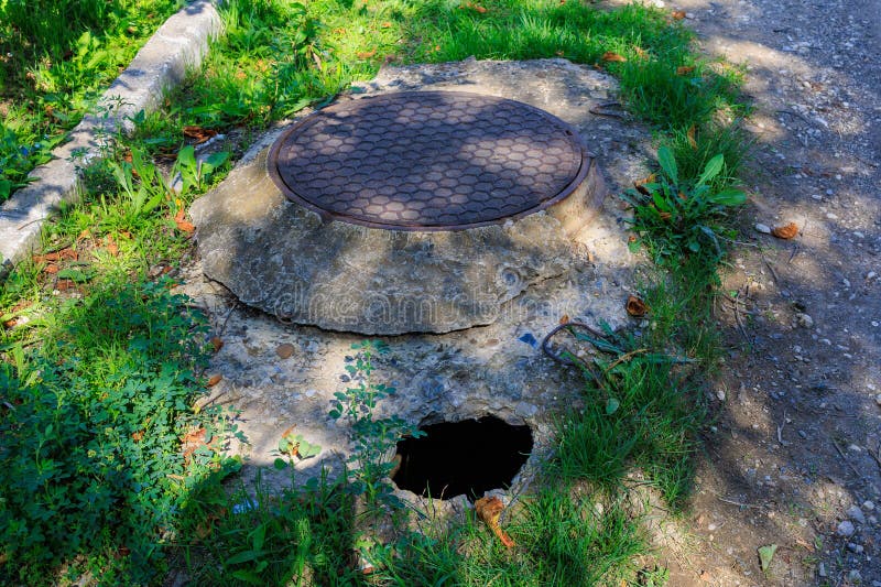 Dangerous Pit of Failed Asphalt Near the Sewer Manhole. Background with ...