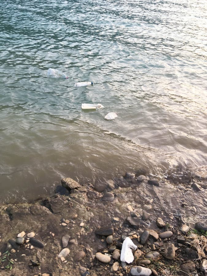 Dangerous Rubbish on a Stony Beach. Photo Showing Pollution Problem ...