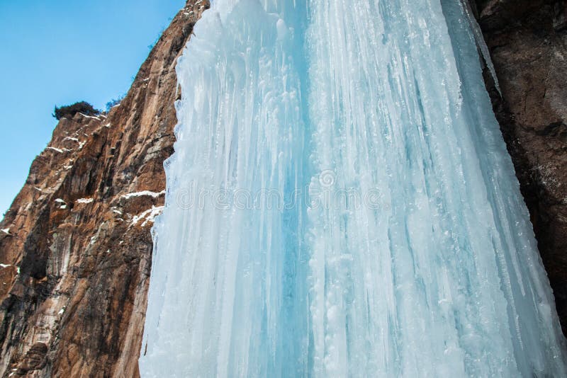 Dangerous Waterfall Frozen in Winter on a Rocky Mountain Stock Image ...