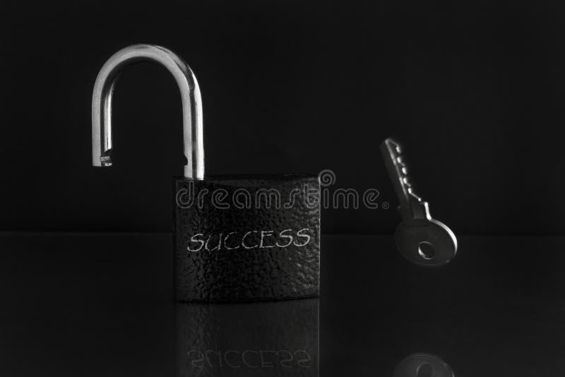 On a Dark Background, an Open Lock with `success`written on it. a Key ...