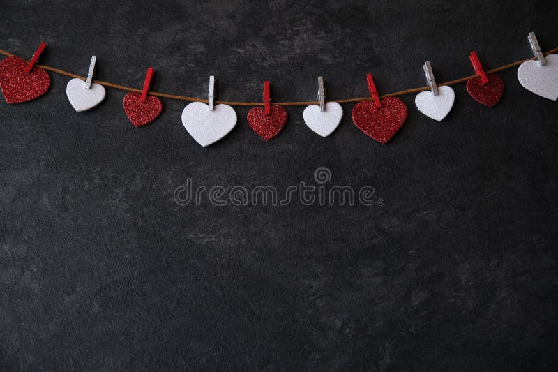 On a Dark Background on a String of Hearts Stock Image - Image of craft ...