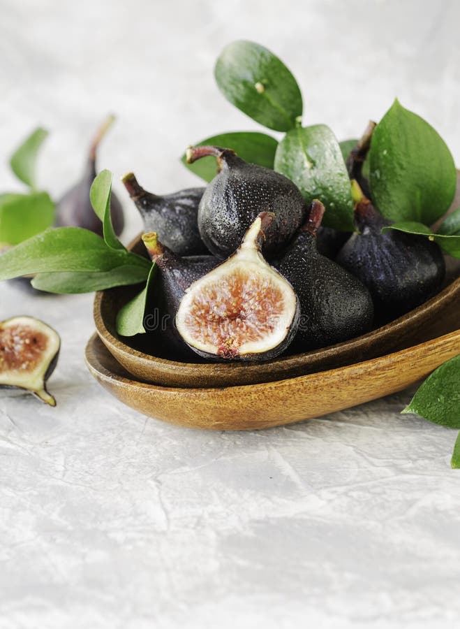 Dark Blue Fresh Figs in a Wooden Bowl on a White Marble Table ...