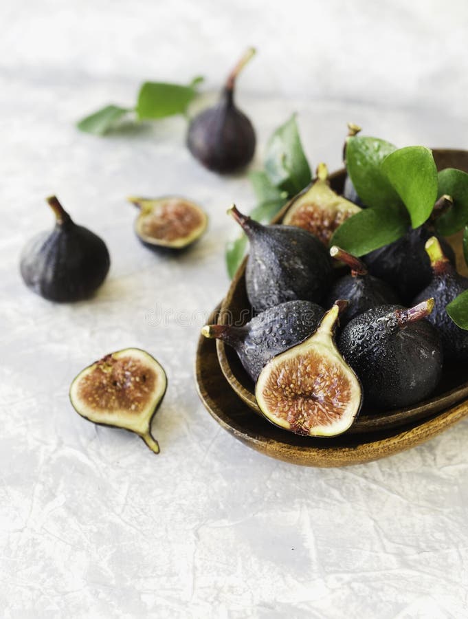 Dark Blue Fresh Figs in a Wooden Bowl on a White Marble Table ...