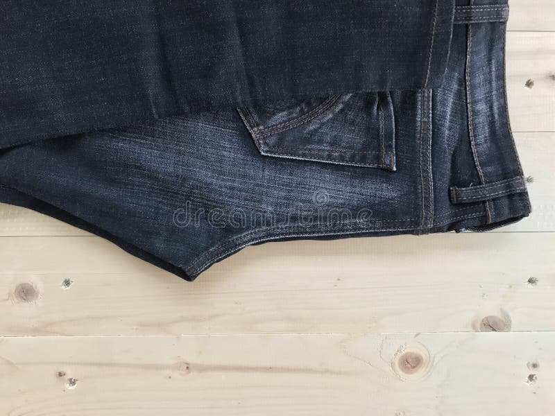 Folded Jeans on Wood Floor with Space for Writing Stock Image - Image ...