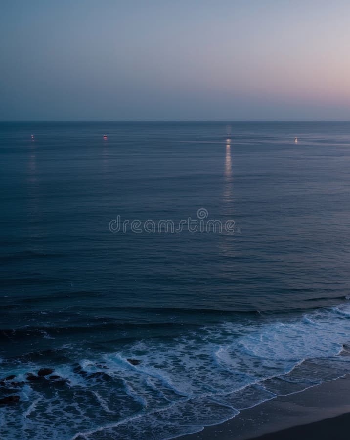 A Dark Blue Ocean with a Few Lights in the Water. Stock Photo - Image ...