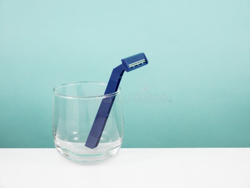 The Dark Blue Plastic Razor and Round Glass Stock Photo - Image of male ...