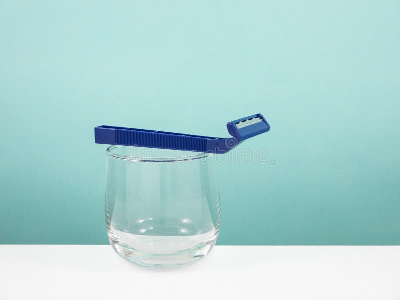 The Dark Blue Plastic Razor and Round Glass Stock Photo - Image of male ...