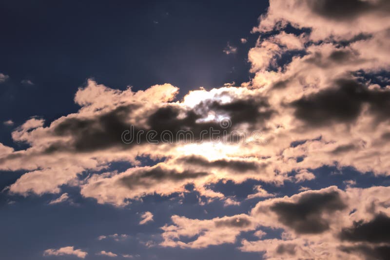 Dark Blue Sky with Fantastic Clouds. Sun is Shining from Behind the ...