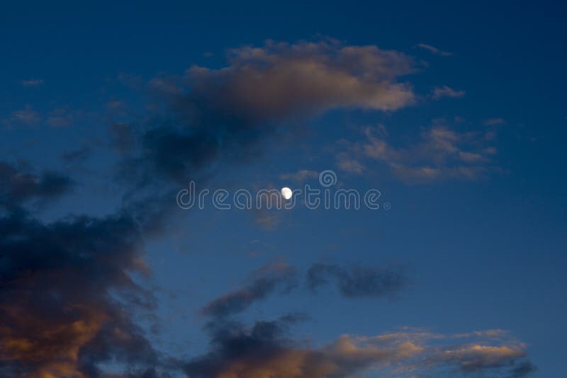 A Dark Blue Sky of Late Sunset with Moon and Multi-colored Clouds Stock ...